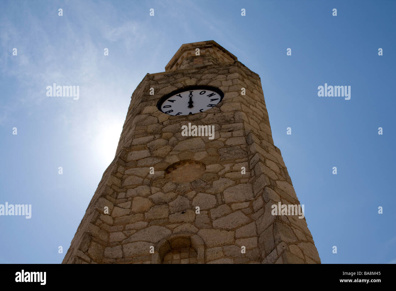 watch tower clock tower blocks the mid day sun as the clock measures ...