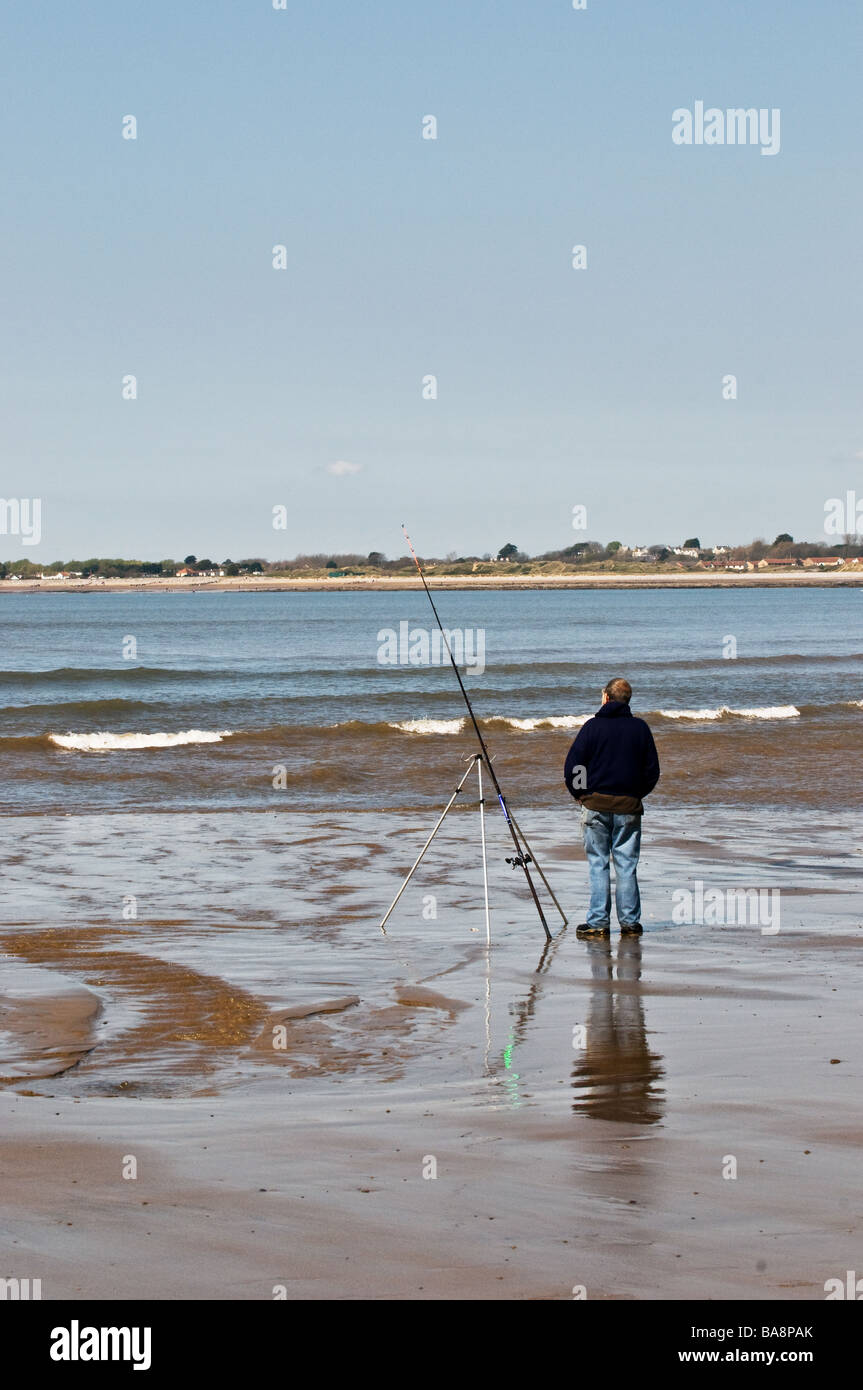 Fisherman angler fishing on beach hi-res stock photography and images ...