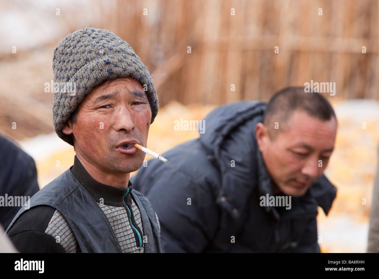 A chinese peasant farmer smoking a cigarette in Heilongjiang province ...