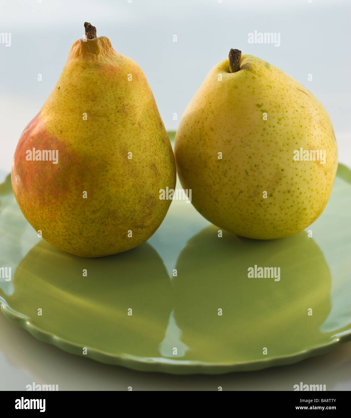 Two pears on a plate Stock Photo - Alamy