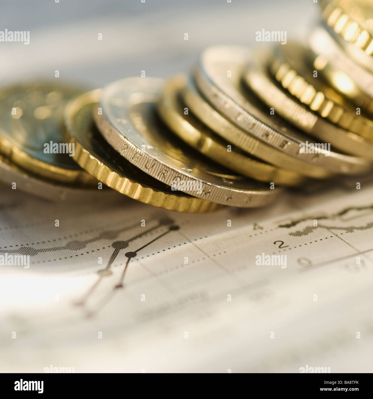 Euro coins on financial graph Stock Photo - Alamy