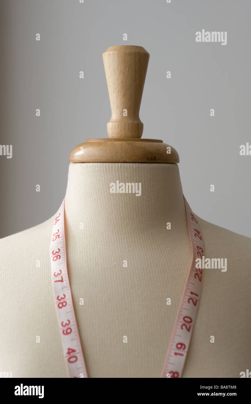 Measuring tape on dressmakers model Stock Photo - Alamy