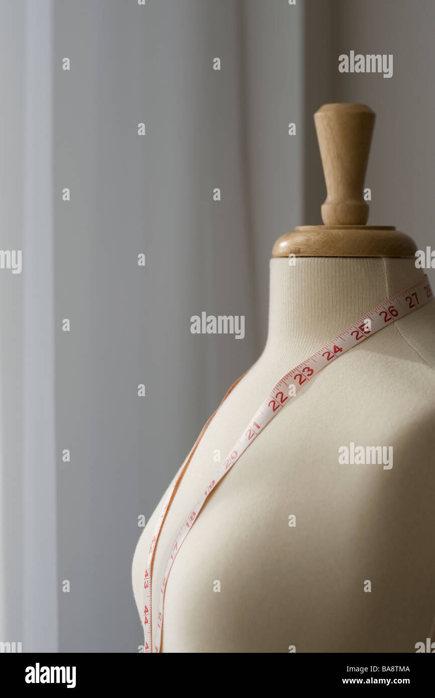 Measuring tape on dressmakers model Stock Photo - Alamy