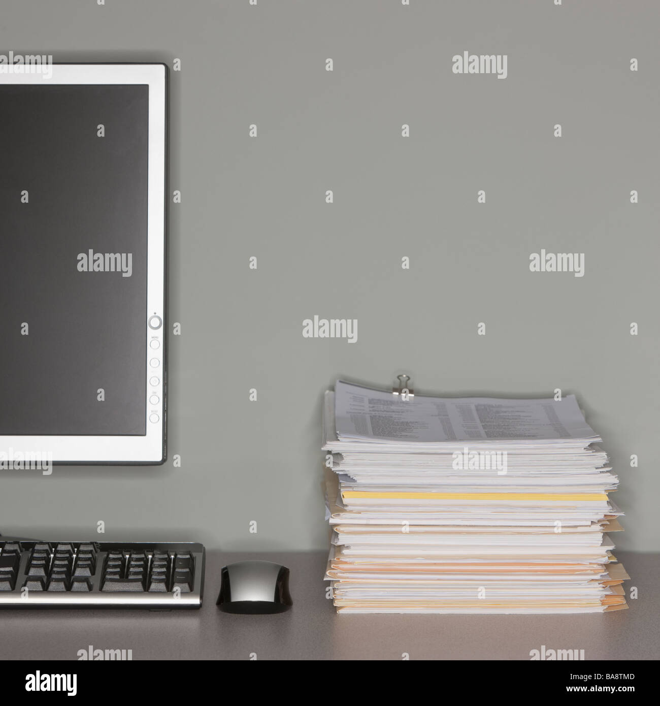 Computer and stack of paperwork Stock Photo - Alamy