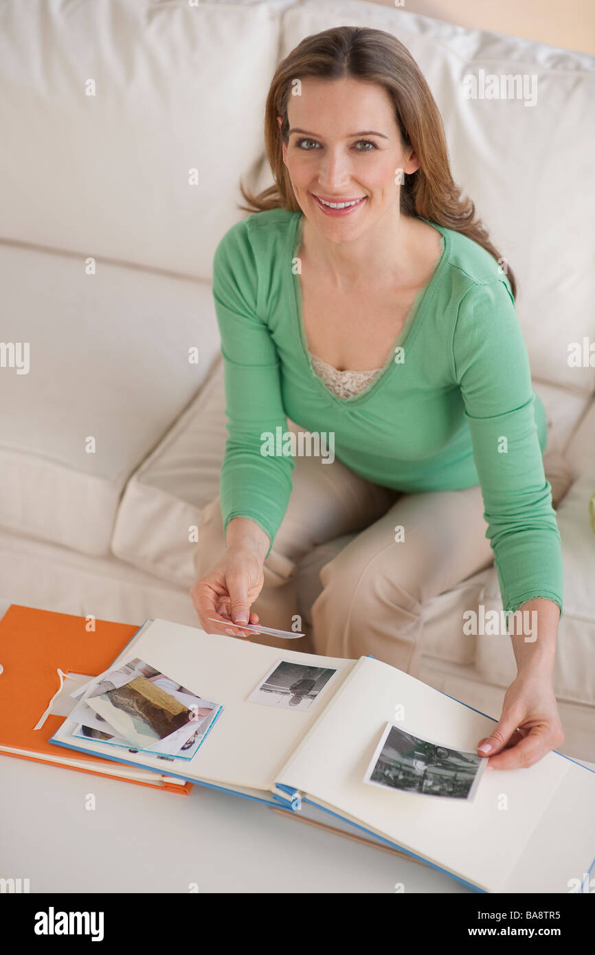 Woman looking at photo album Stock Photo - Alamy