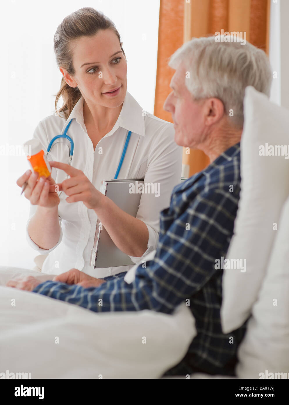 Nurse explaining prescription to senior man Stock Photo - Alamy