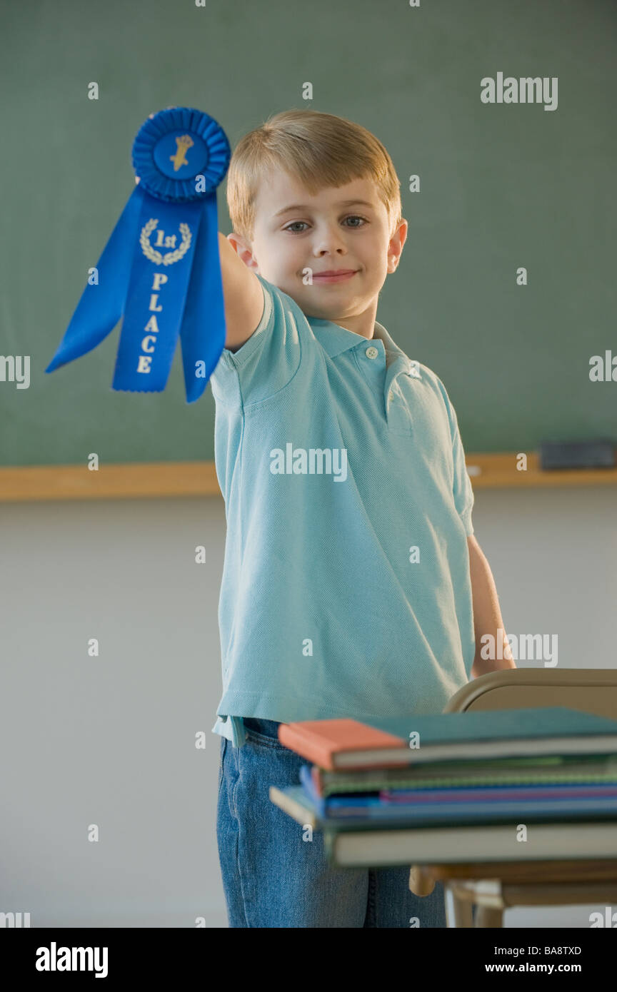 Boy holding first place ribbon Stock Photo - Alamy