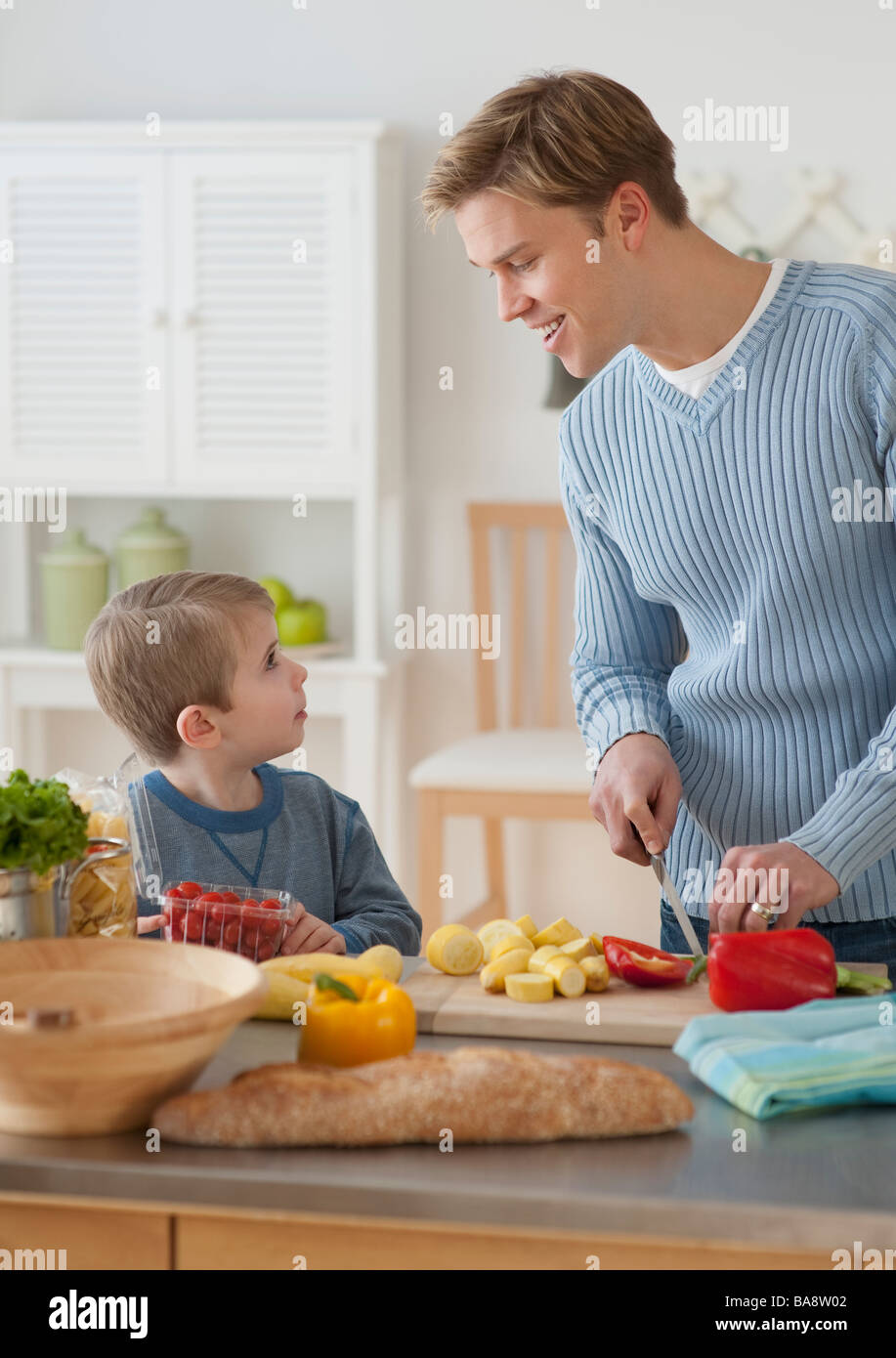 Son helping father cook hi-res stock photography and images - Alamy