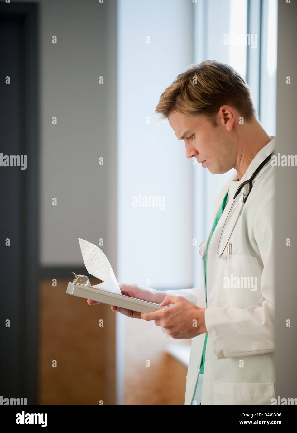Doctor reading medical chart Stock Photo - Alamy