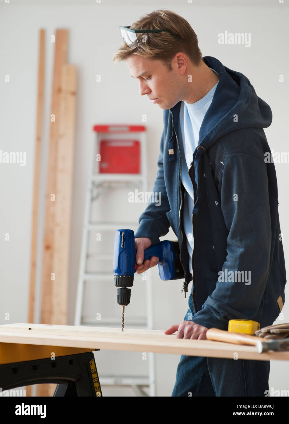 Man drilling on board Stock Photo - Alamy