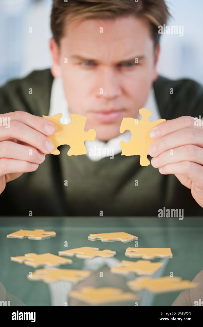 Businessman looking at puzzle pieces Stock Photo - Alamy Businessman looking at puzzle pieces Stock Photo - Alamy