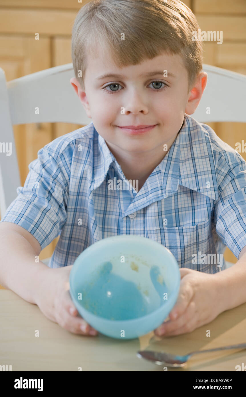 Boy showing empty bowl Stock Photo - Alamy