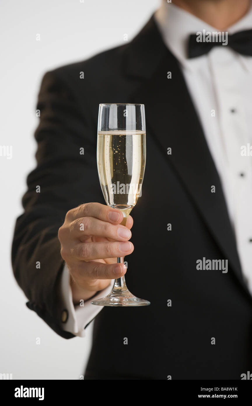 Man in tuxedo toasting with champagne Stock Photo - Alamy