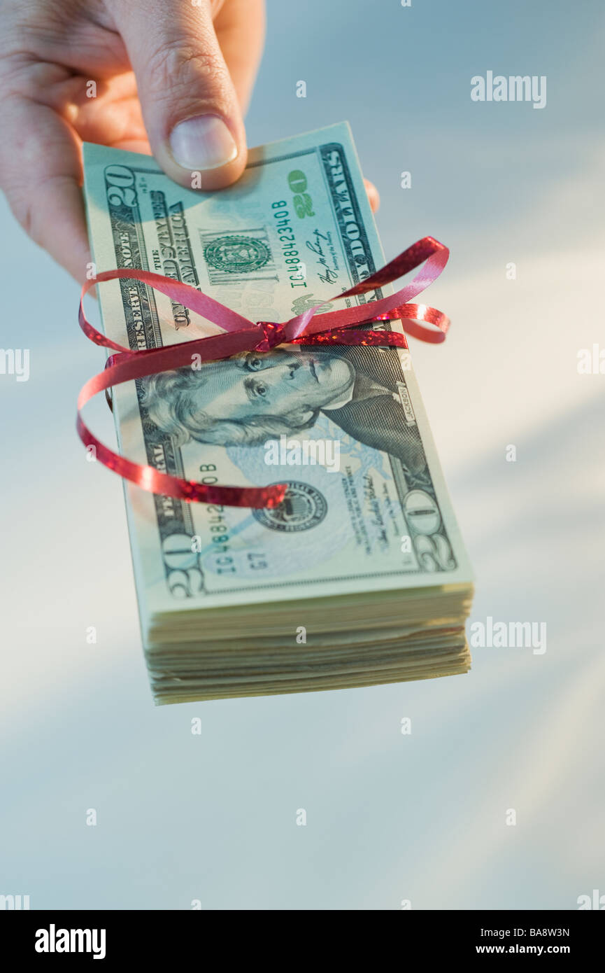 Man holding stack of money wrapped in ribbon Stock Photo - Alamy