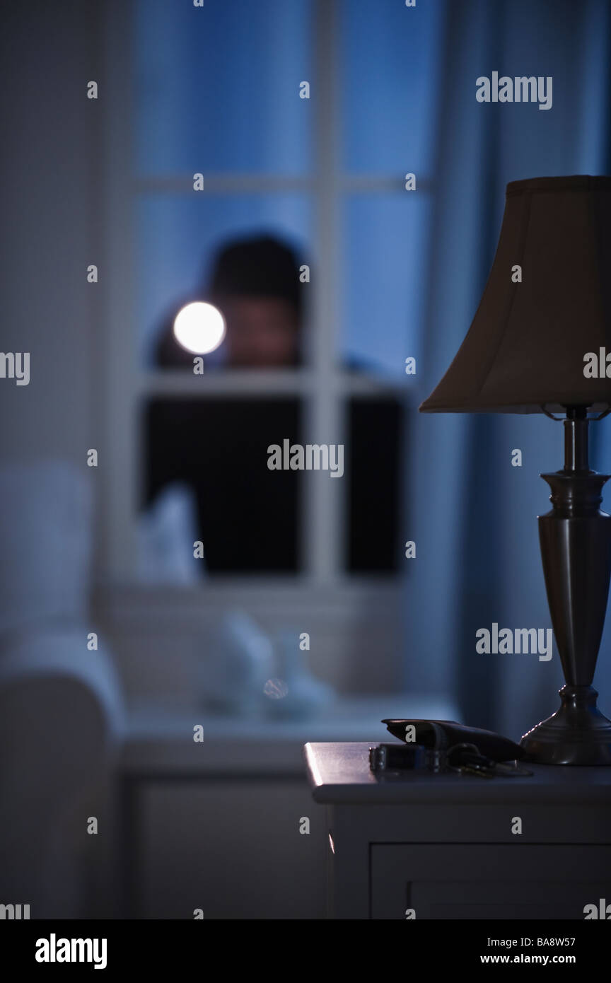 Burglar looking in house window Stock Photo - Alamy