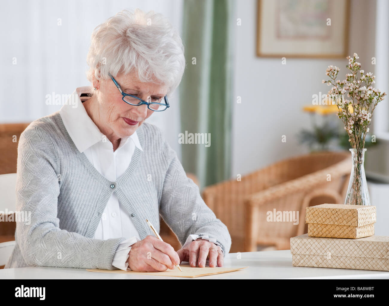 Senior woman writing letter Stock Photo - Alamy
