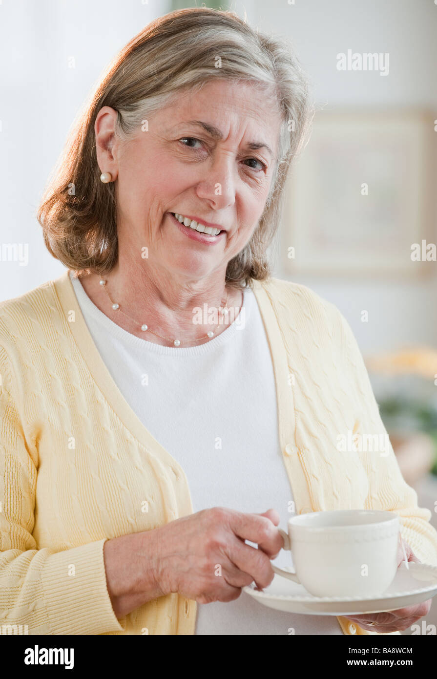Senior woman drinking tea Stock Photo - Alamy