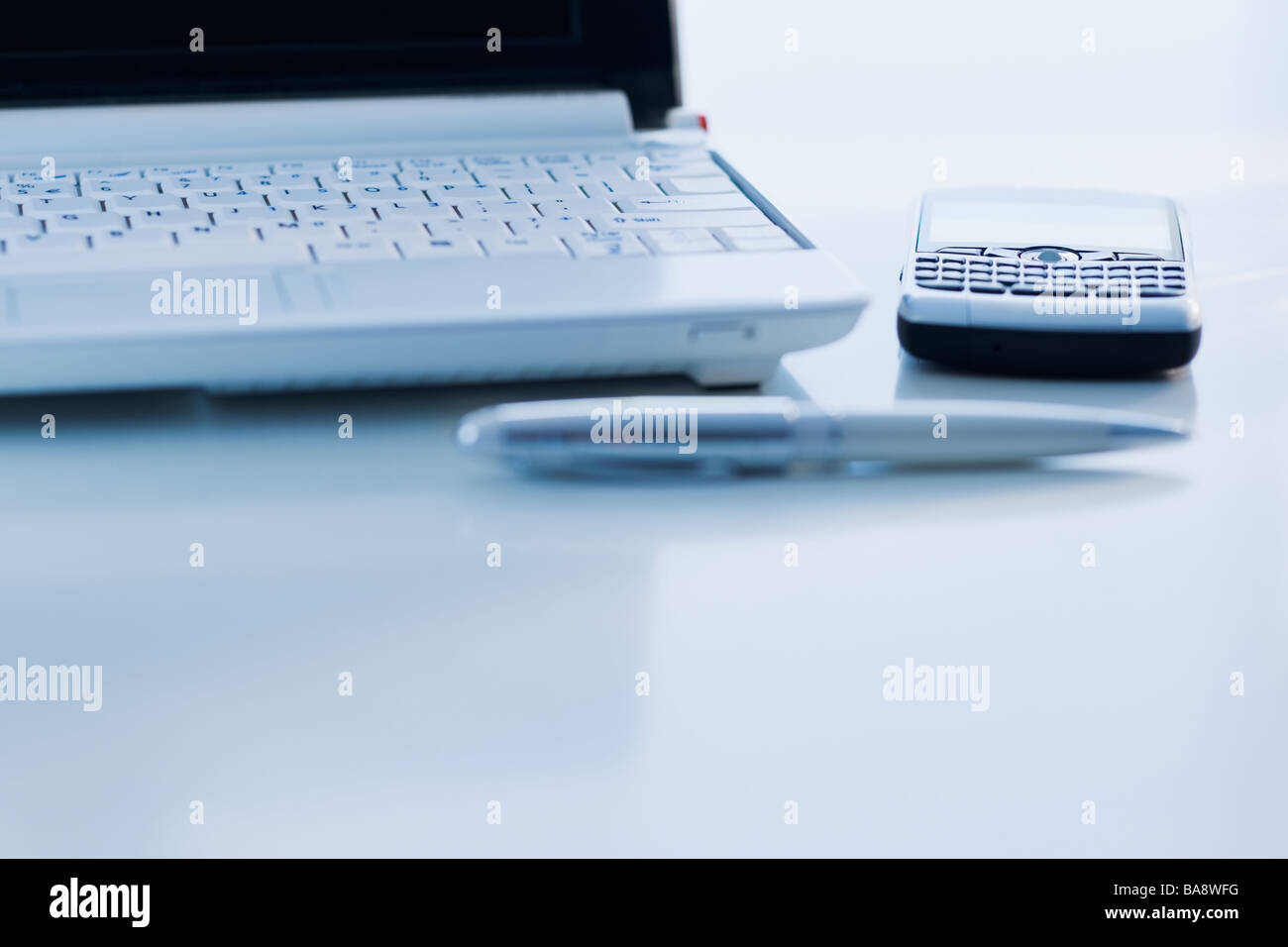 Cell phone and laptop on desk Stock Photo - Alamy