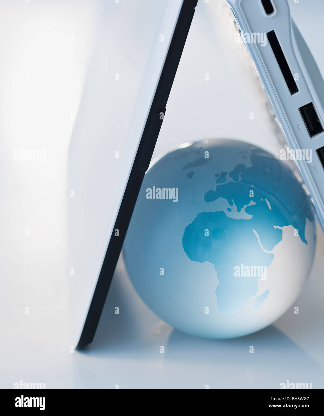 Globe inside laptop Stock Photo - Alamy