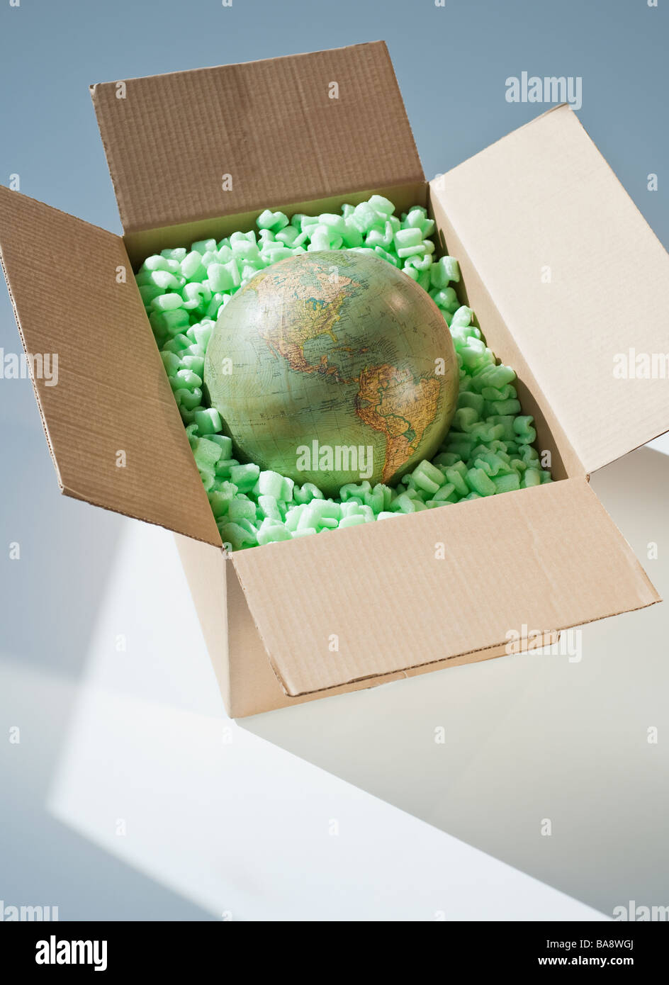 Globe in shipping box Stock Photo - Alamy
