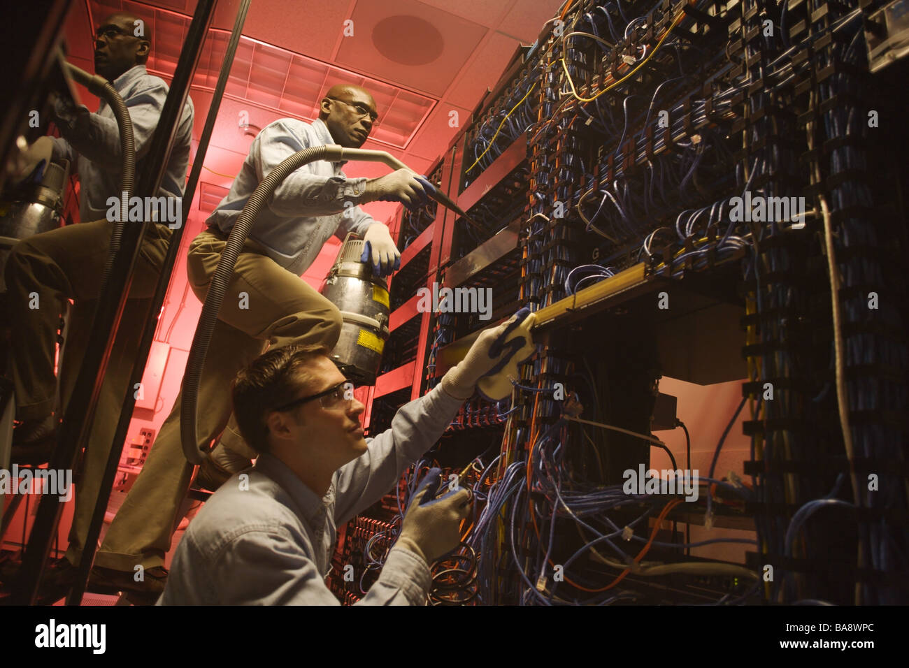 Computer technicians clean servers in high tech environment Stock Photo ...