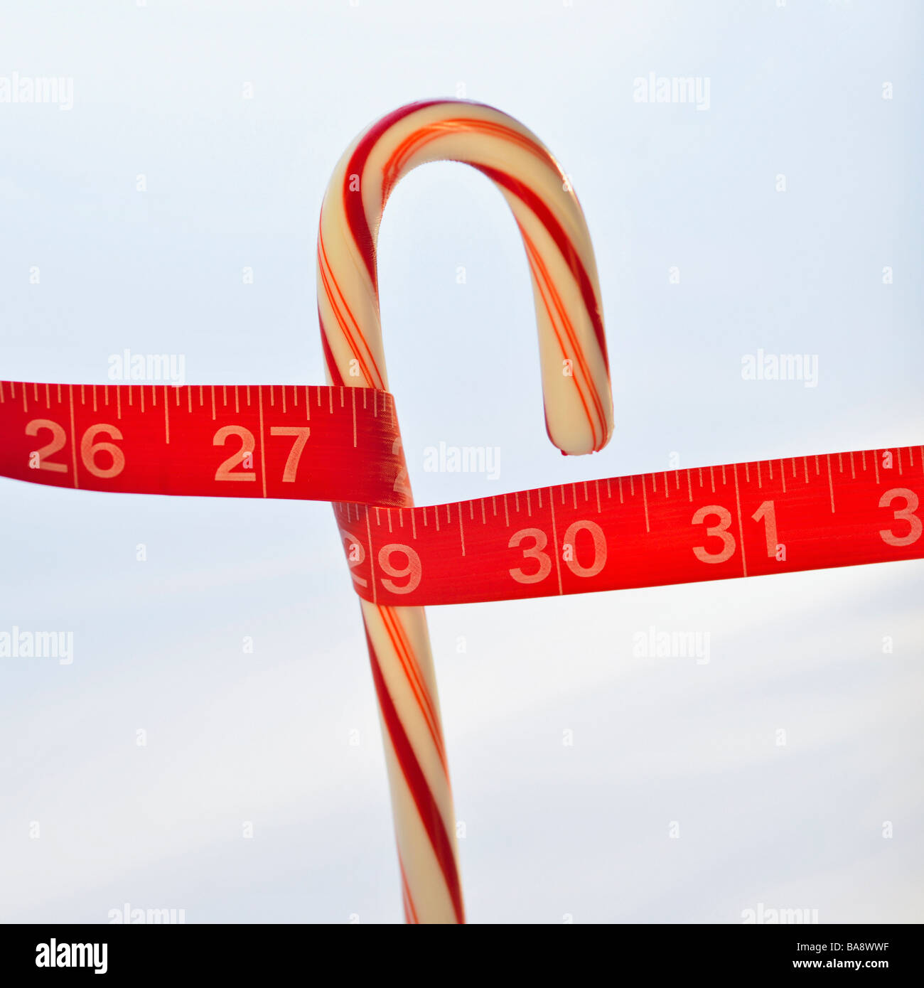 Measuring tape around candy cane Stock Photo - Alamy