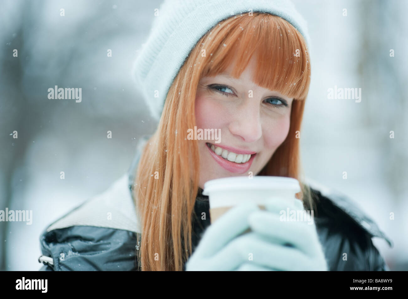 Woman drinking coffee in snow Stock Photo - Alamy