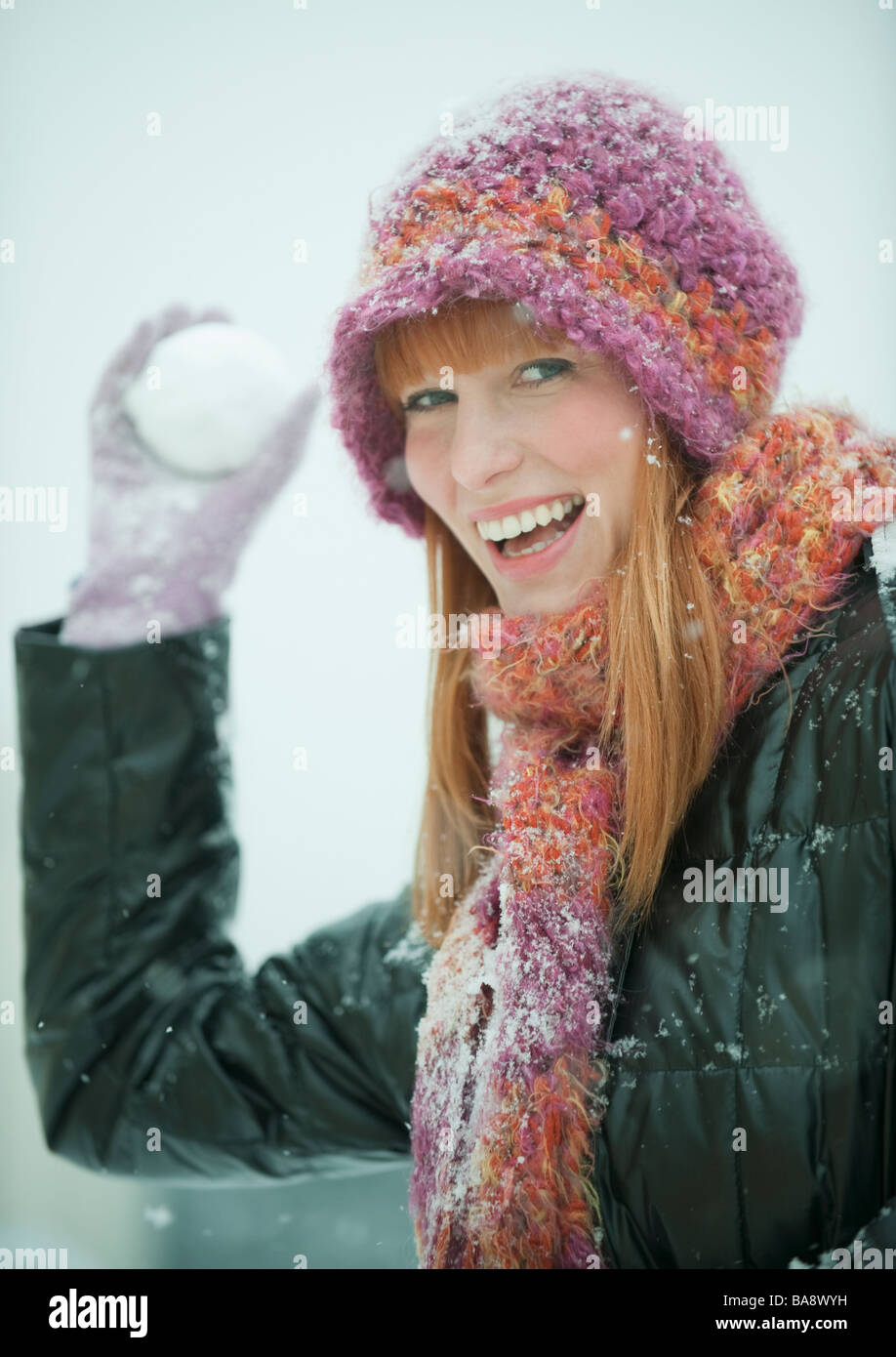 Woman throwing snowball Stock Photo - Alamy