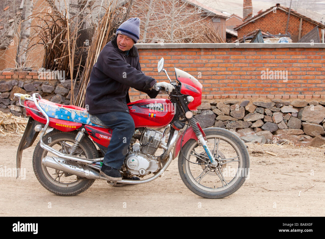 A chinese man on a motorbike in Heilongjiang province in Norhern China ...