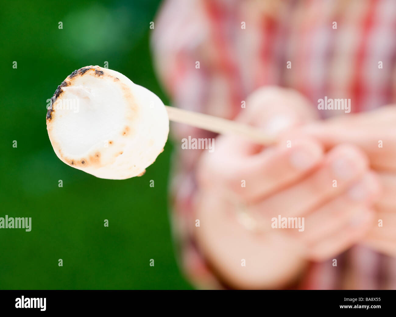 Boy holding roasted marshmallow Stock Photo - Alamy