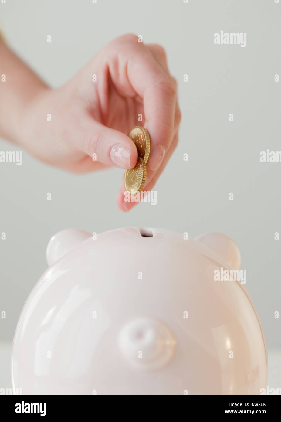 Female hand dropping coin hi-res stock photography and images - Alamy