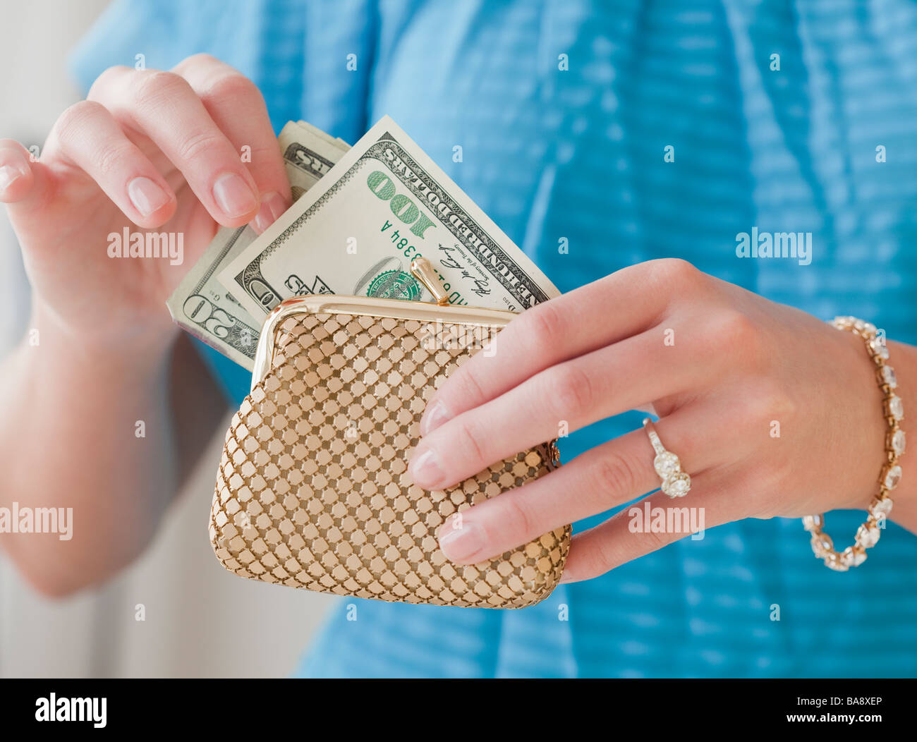Woman pulling money from change purse Stock Photo - Alamy