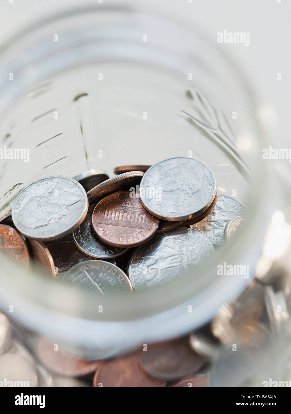 Coins in savings jar Stock Photo - Alamy