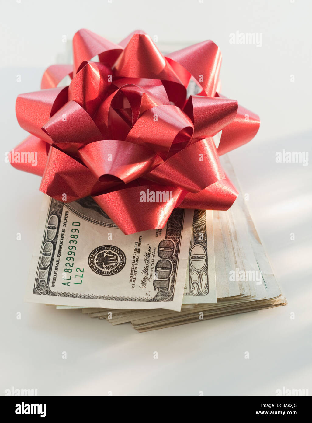 Bow on stack of money Stock Photo - Alamy