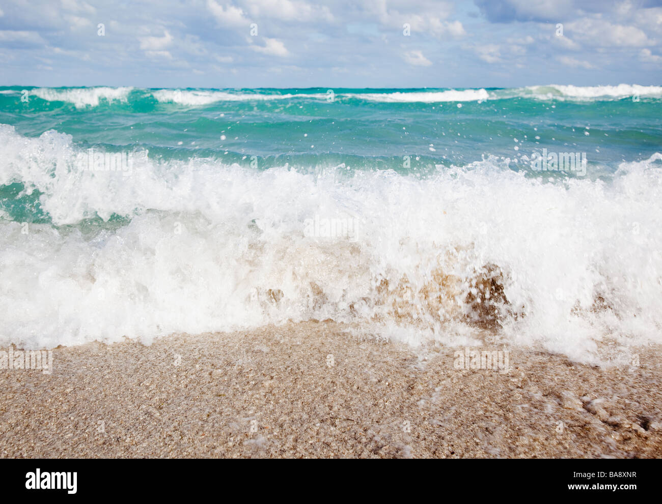 Waves crashing on beach Stock Photo - Alamy