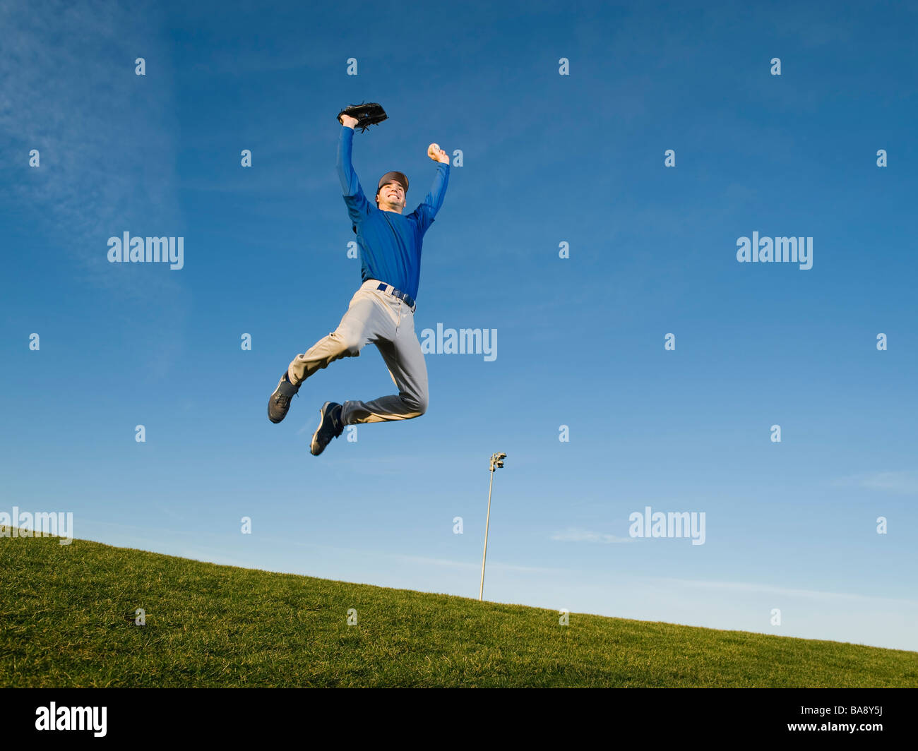Baseball player jumping in air Stock Photo - Alamy
