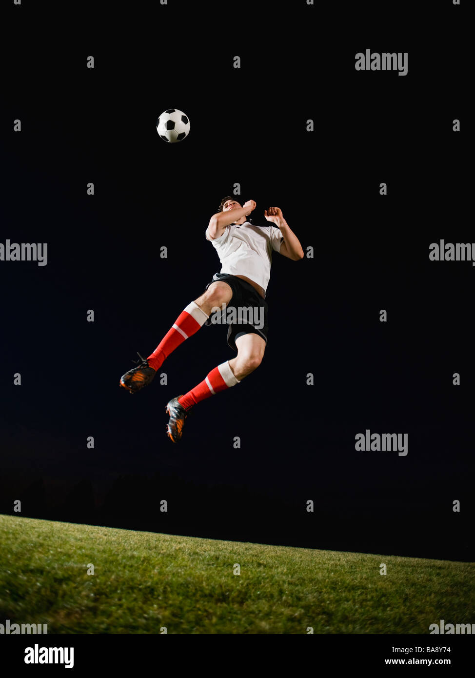 Soccer player heading ball Stock Photo - Alamy