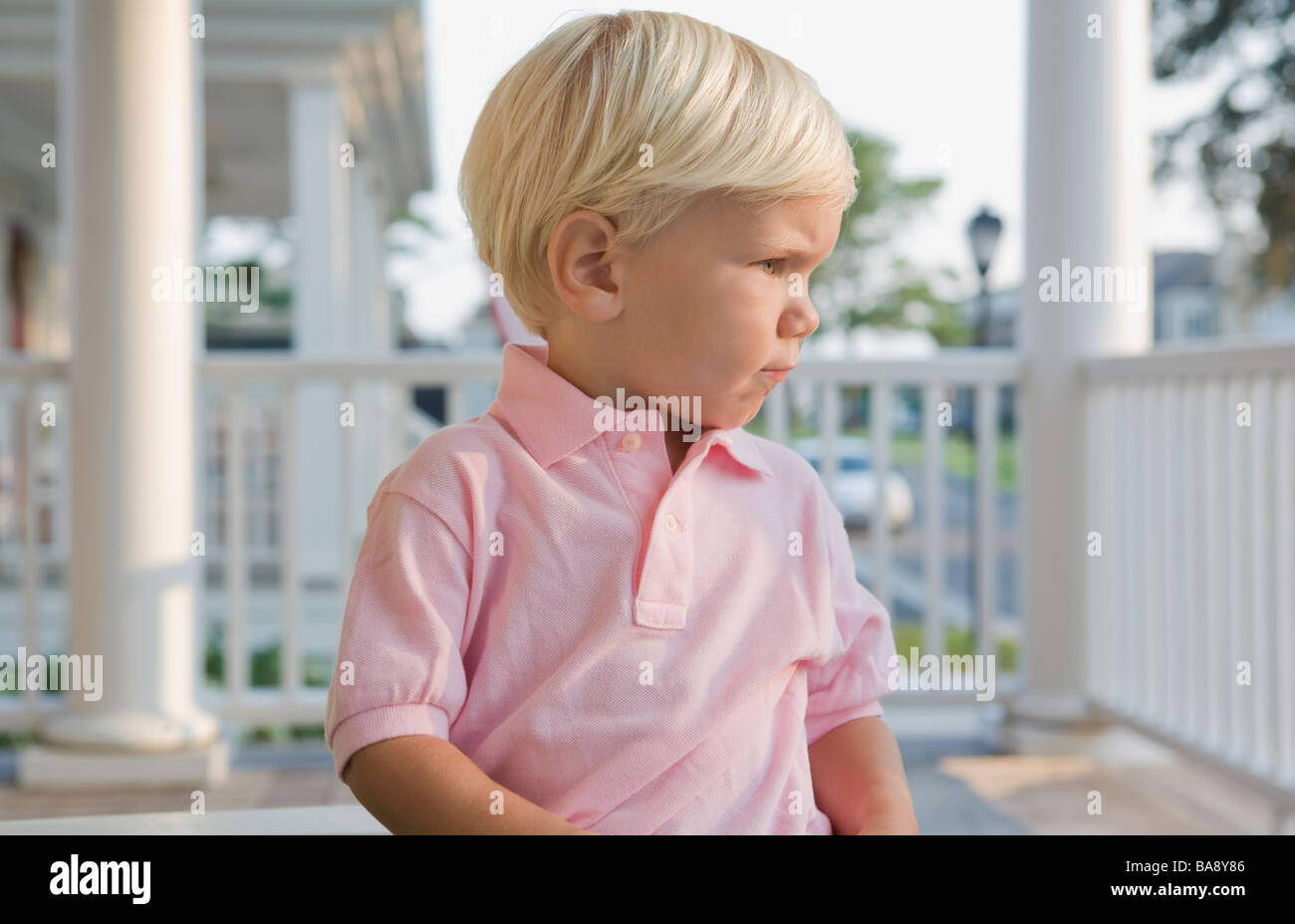 Boy sitting on porch Stock Photo - Alamy