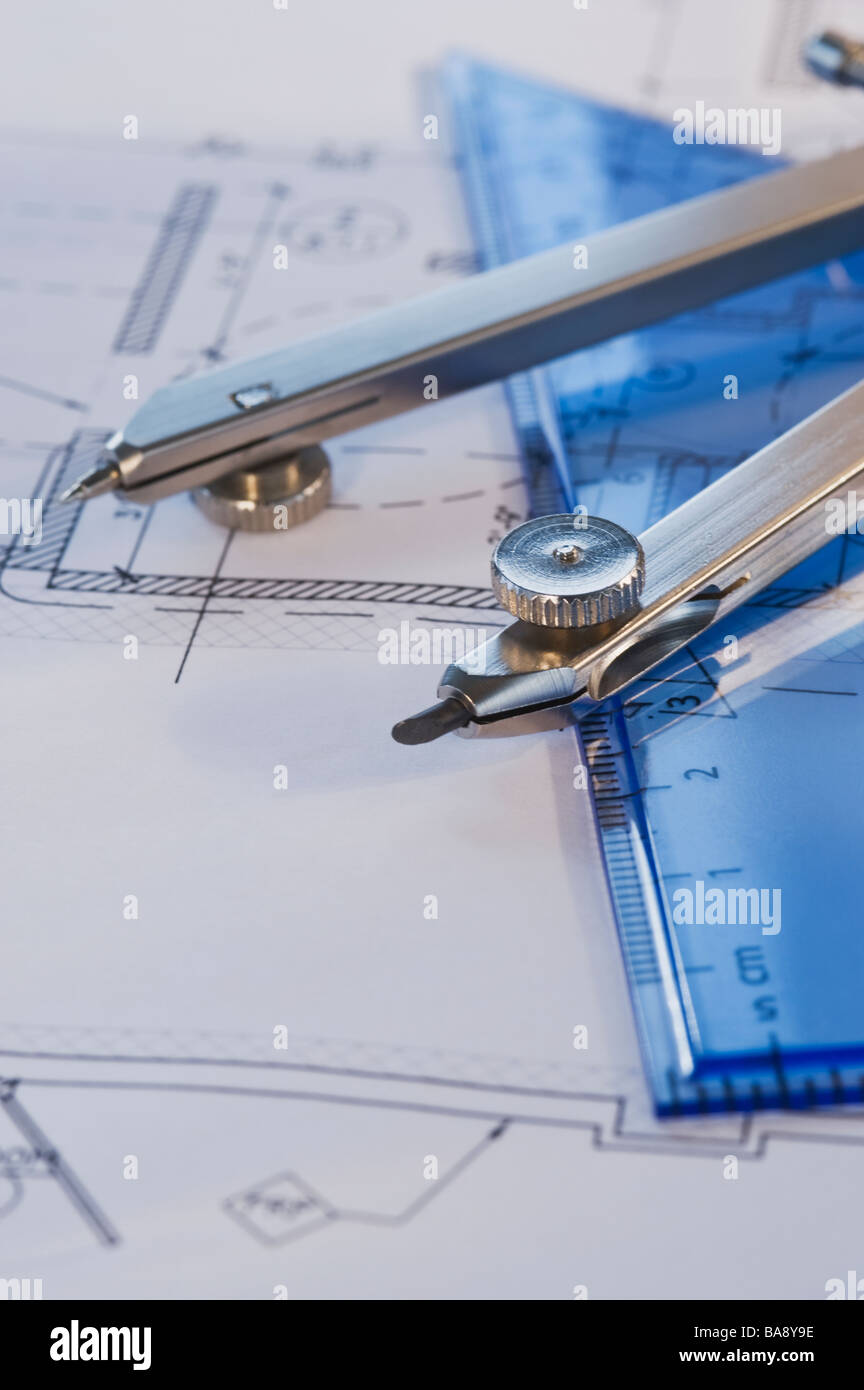 Drawing compass and blueprints Stock Photo - Alamy