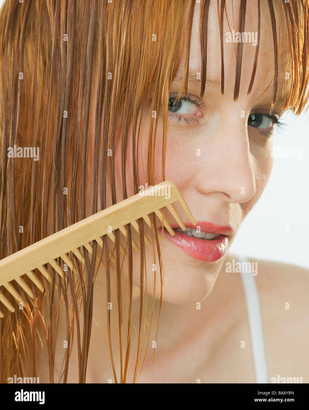 Woman combing hair Stock Photo - Alamy