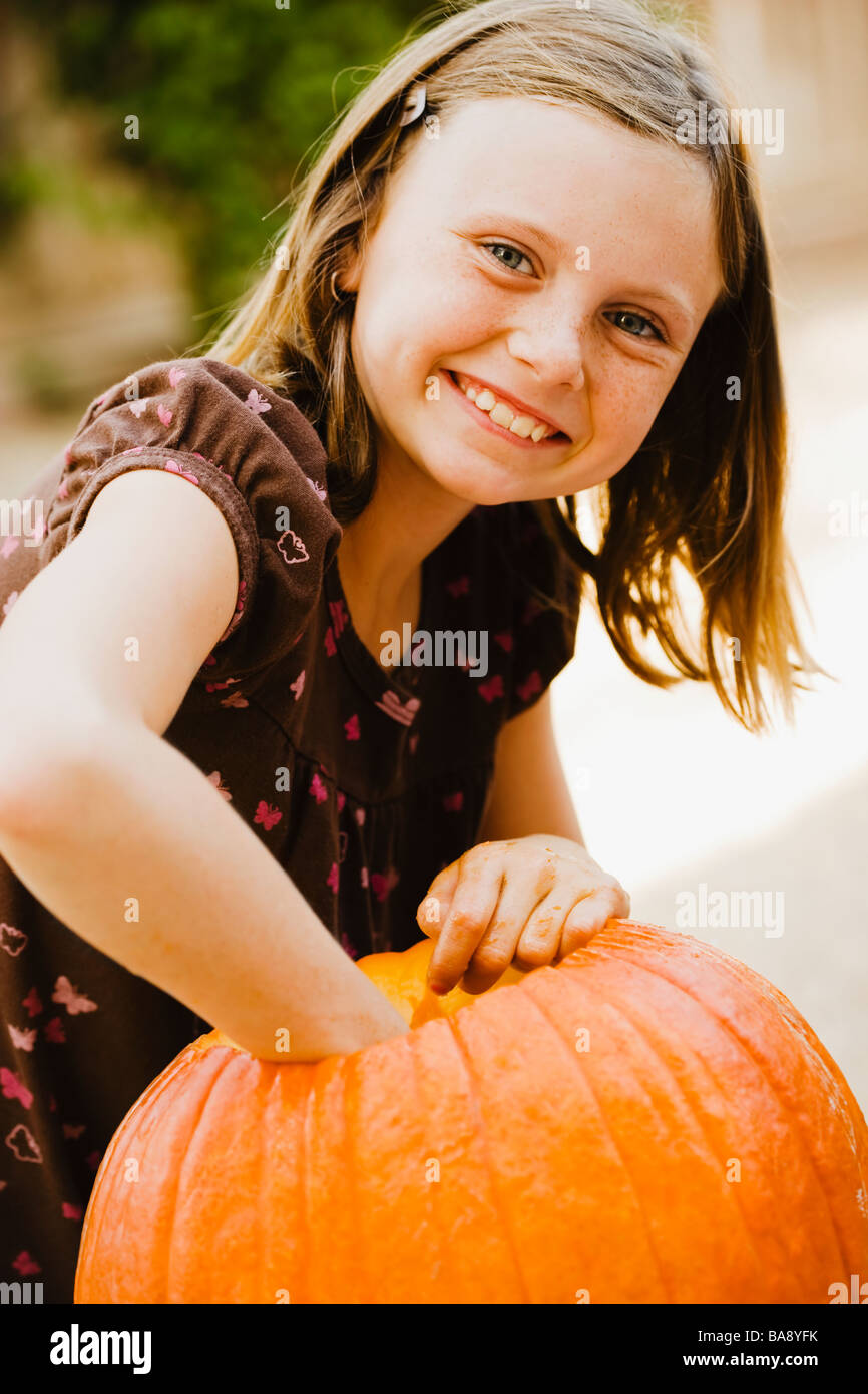Girl scooping out pumpkin Stock Photo - Alamy