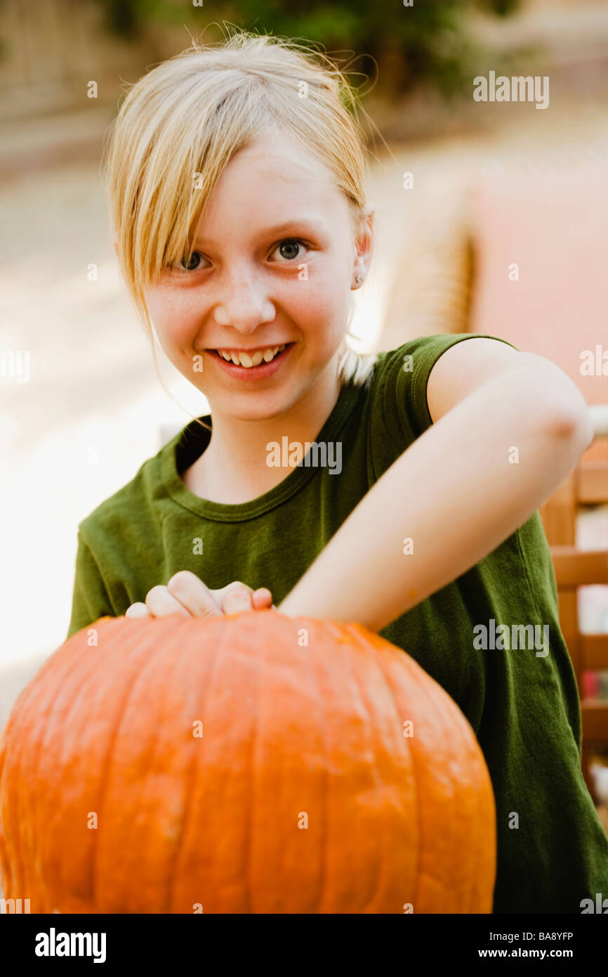 Girl scooping out pumpkin Stock Photo - Alamy