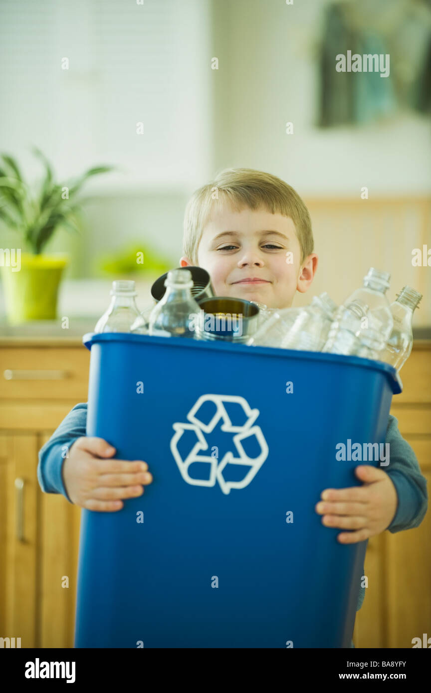 Boy carrying full recycling bin Stock Photo - Alamy