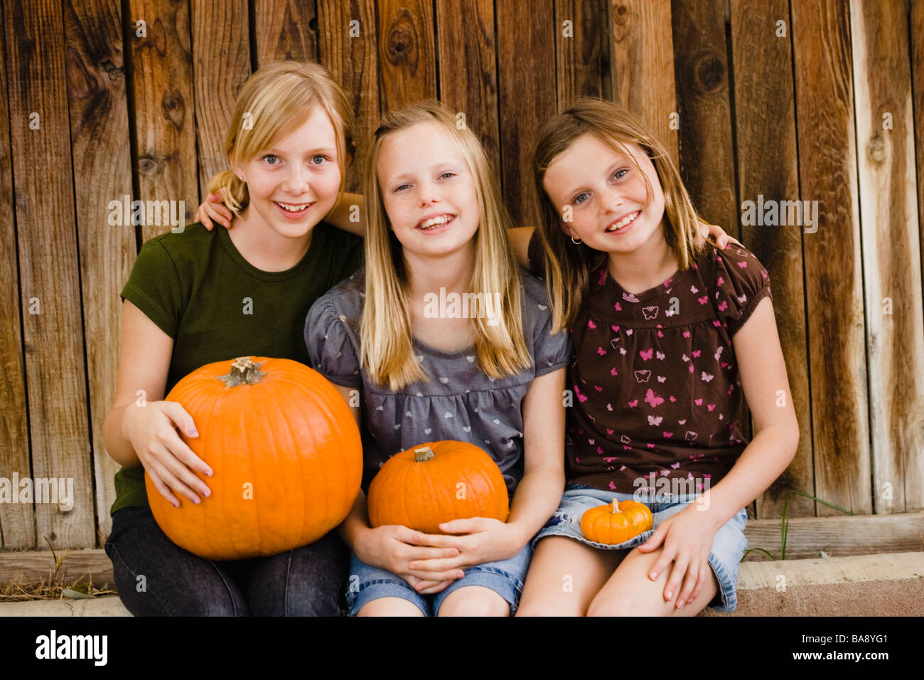 Girls holding pumpkins Stock Photo - Alamy