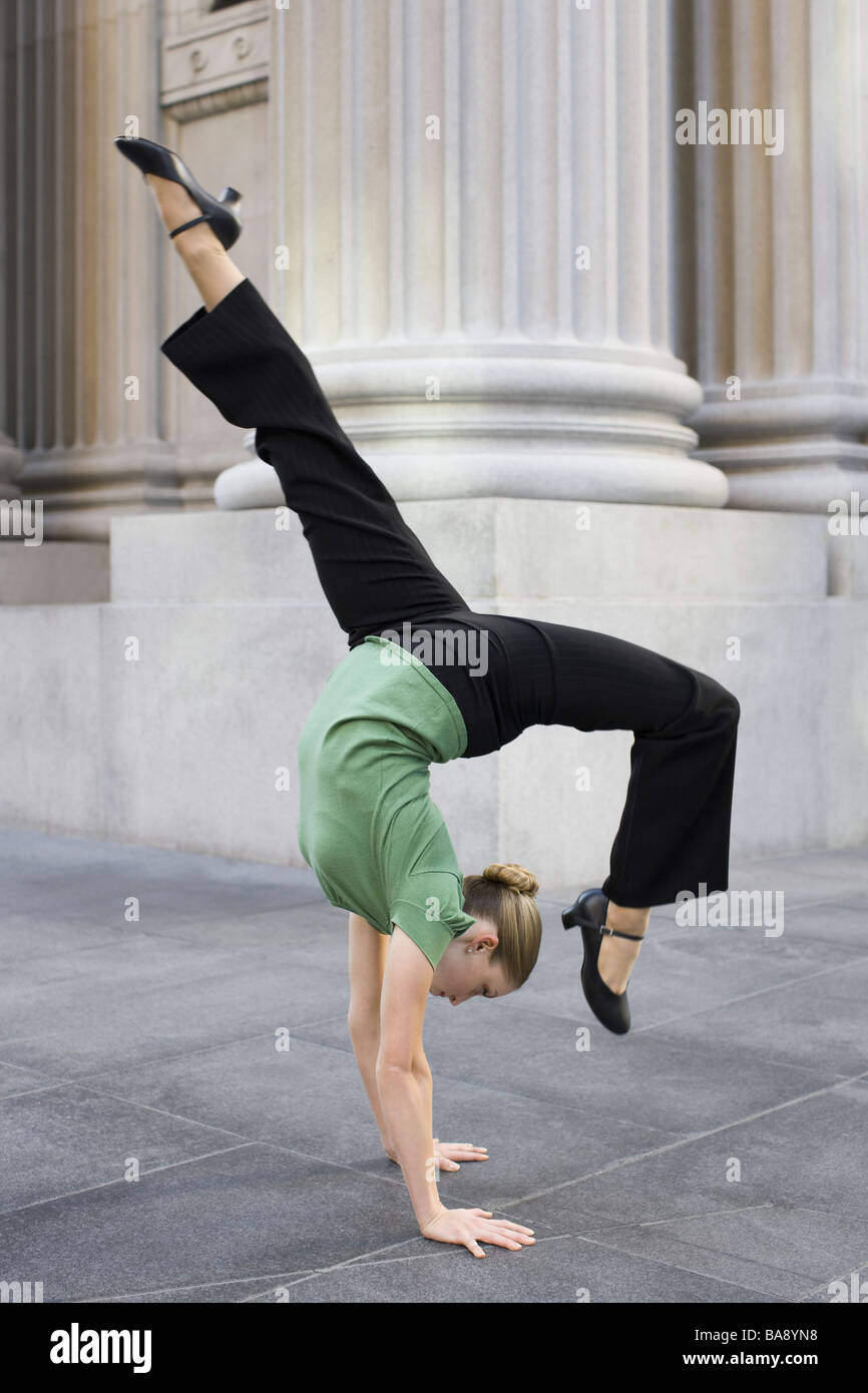 Businesswoman dancing on urban sidewalk Stock Photo - Alamy