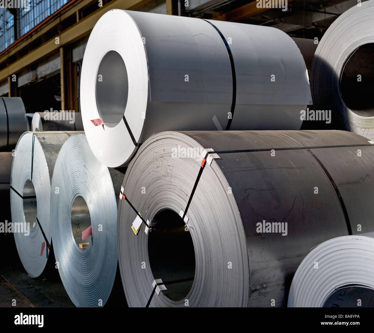 Rolls of steel in warehouse Stock Photo - Alamy