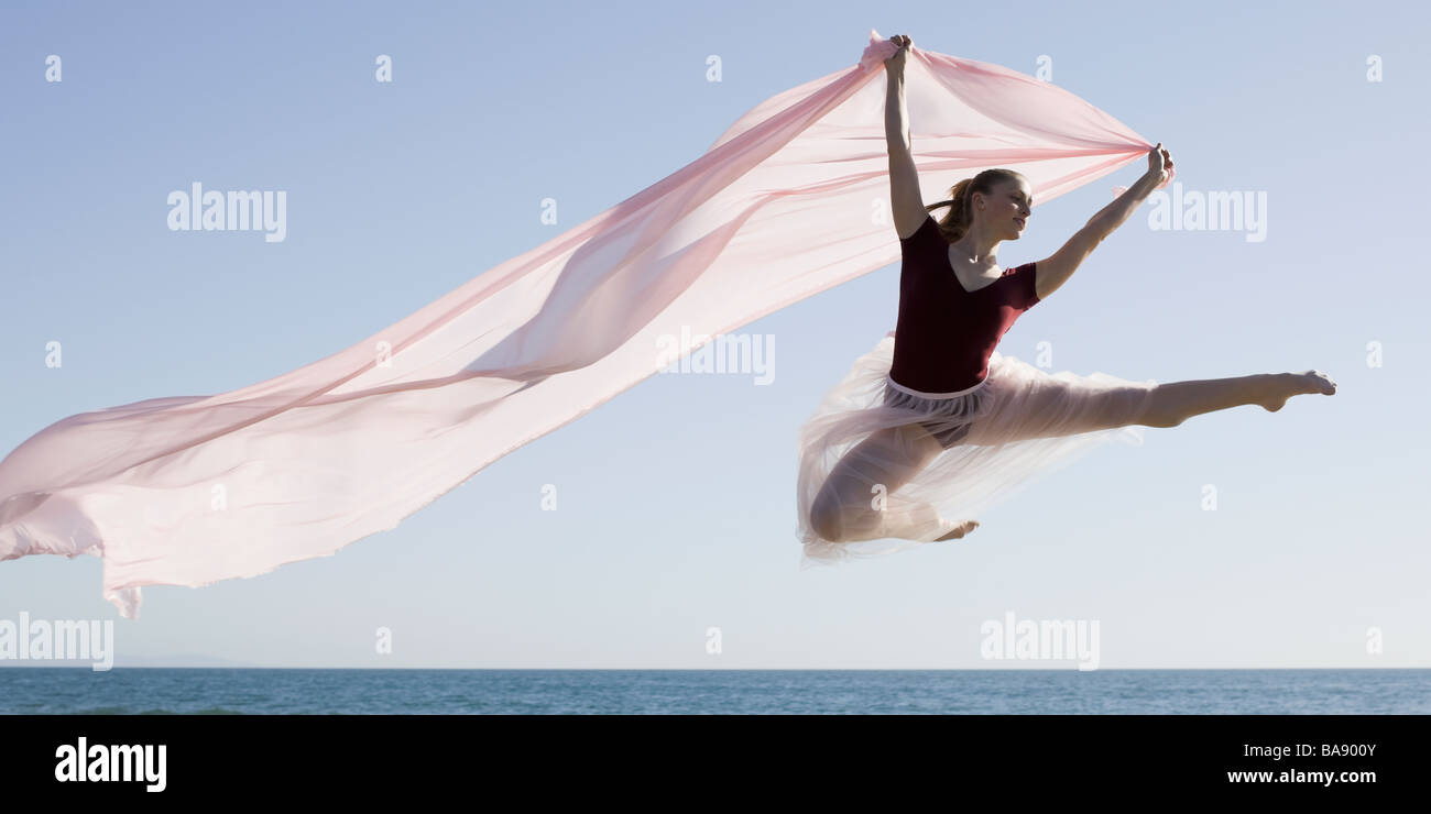 Dancer leaping on beach Stock Photo - Alamy
