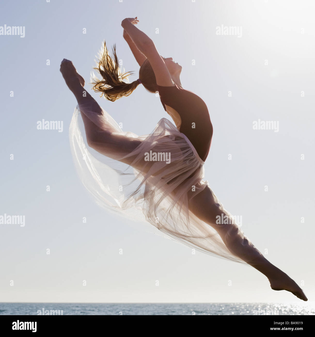 Dancer leaping on beach Stock Photo - Alamy