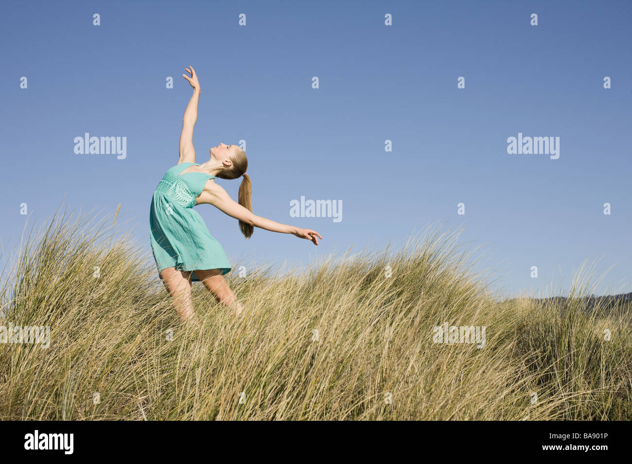 Woman dancing on sand dunes Stock Photo - Alamy