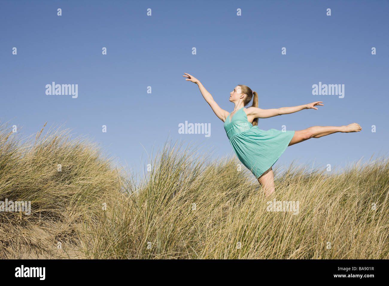 Woman dancing on sand dunes Stock Photo - Alamy
